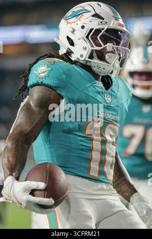 Miami Dolphins punter Jake Bailey (16) holds the ball as kicker Riley ...