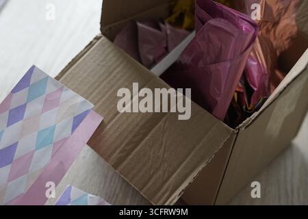 Festive outdoor display of colorful wrapped gift boxes alongside shiny ...