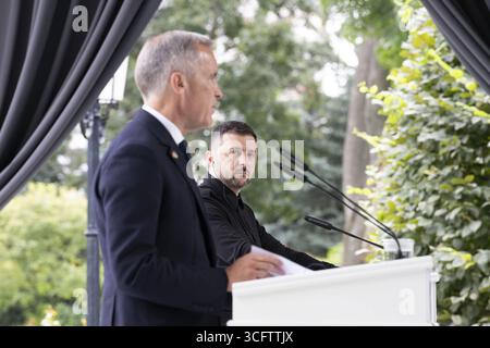 Prime Minister Mark Carney looks on as Mark Miller is sworn in as ...