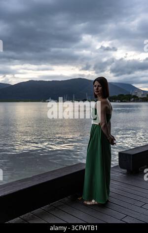 relaxing young woman on wooden pier at the calm lake Stock Photo - Alamy