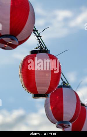 Red and white Japanese lanterns (chochin, chouchin) in front of a ...