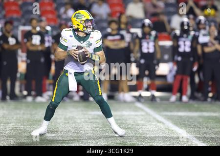 Edmonton Elks quarterback Cody Fajardo, right, hands the ball off to ...