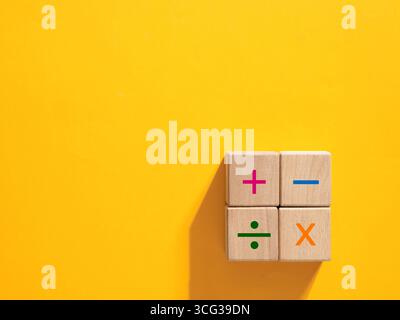 Wooden cubes with numbers and mathematical symbols on light background ...