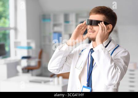 Male doctor in AR glasses using virtual screen on light background ...
