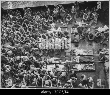 Coast Guard-manned landing craft pass an abandoned Japanese boat as ...