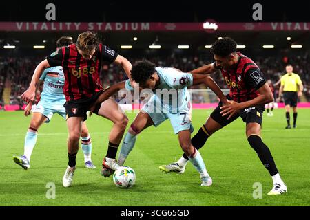 Brentford's Kevin Schade (centre) battles for the ball with Bournemouth ...