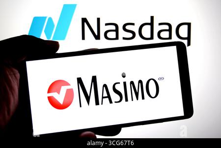 In this photo illustration, Masimo logo seen on a smartphone and a pc ...