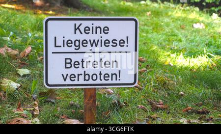 CAUTION text written on green zig-zag stamp sign Stock Photo - Alamy