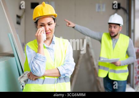 Woman engineer crying because she has been fired by her foreman Stock ...