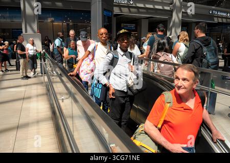 People take the escalators in Moynihan Train Hall in Manhattan, New ...