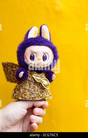 Adorable purple character in a yellow container with a happy face ...