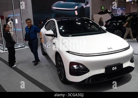 Visitors inspect a Xpeng G6 car during the 42nd Thailand International ...