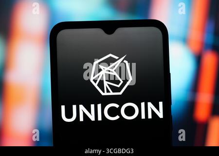 In this photo illustration, the Unicoin logo is seen displayed on a ...