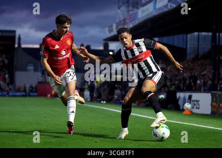 Grimsby Town's Evan Khouri (second from left) and Brentford's Frank ...