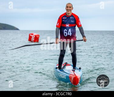 Stand up paddleboard athlete competing on the open water during a GBSUP ...