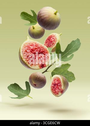 Fresh figs and green leaves falling on pastel pink background Stock ...