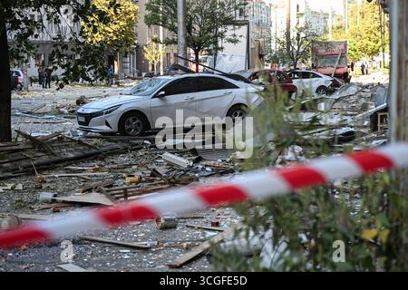 Cars damaged during a Russian strike sit parked amid debris in Kryvyi ...