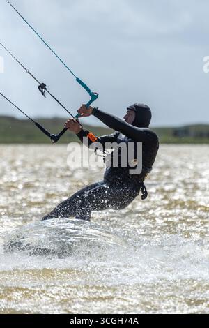 Kitesurfer riding ocean waves on a bright sunny day Stock Photo - Alamy