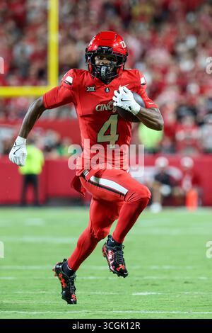 Cincinnati wide receiver Cyrus Allen (4) gets tripped up by Kansas ...