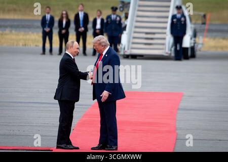 President Donald Trump, right, shakes the hand of Nassau County ...