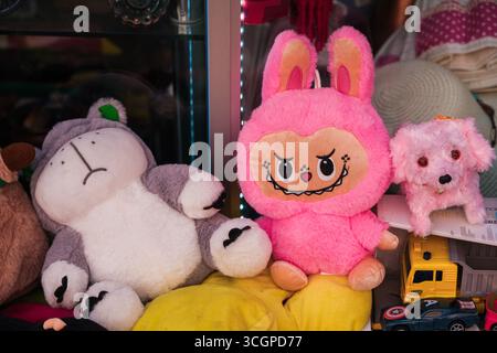 A variety of plush animal toys, including Beanie Babies, are neatly ...