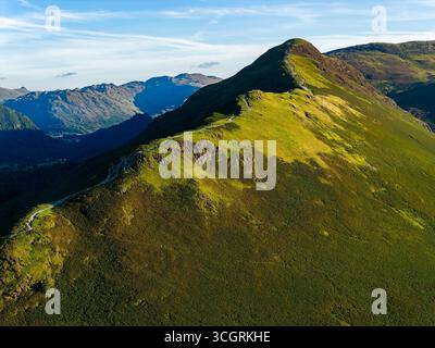 Golden sunset illuminating green mountain valley with forest hills ...