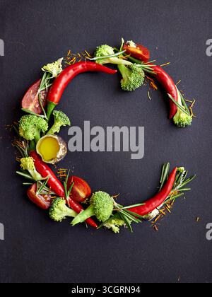 Letter C formed from fresh vegetables high in vitamin C - kale, sweet ...