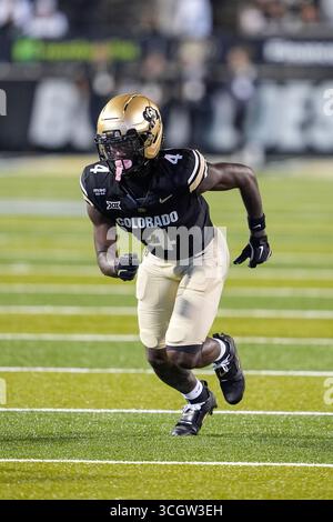 Colorado wide receiver Omarion Miller, center, runs for a short gain ...