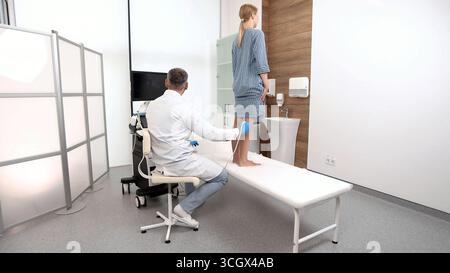 Leg venous ultrasound . Doctor sonographer examines veins condition of ...