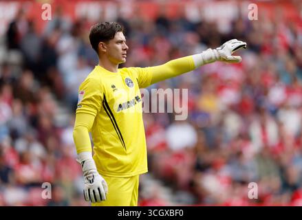Sheffield United goalkeeper Michael Cooper makes a save from the shot ...