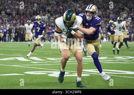 Washington safety Alex McLaughlin (12) tackles UCLA quarterback Nico ...