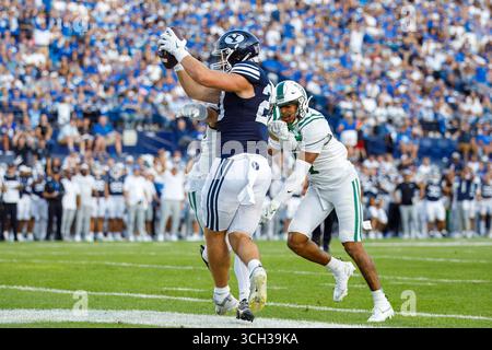 BYU tight end Carsen Ryan, front left, prepares to be hit by East ...