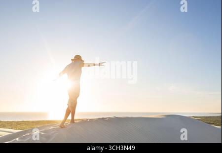 Hiker among sand dunes in the desert Stock Photo - Alamy