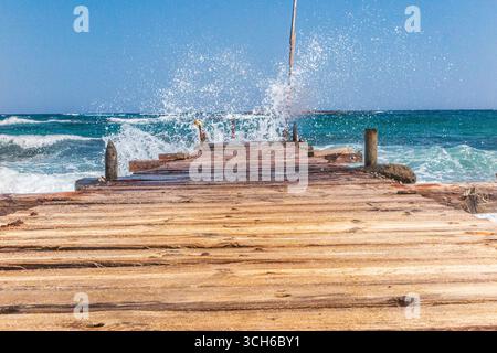 A jetty takes the brunt of waves from the Mediterranean sea Stock Photo ...