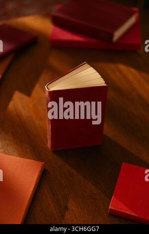 A book with fanned-out pages, with a warm light highlighting its pages ...
