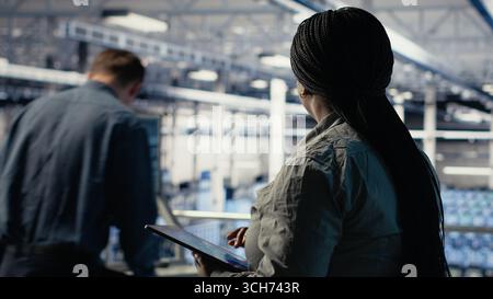 Data center employee monitoring infrastructure processes, reviewing ...