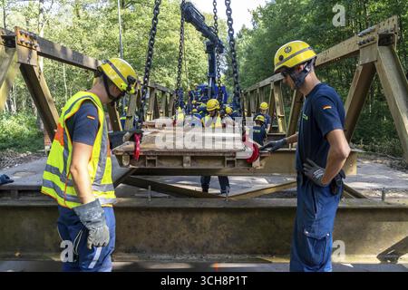 Construction of a temporary bridge over a slipped road crossing a ...