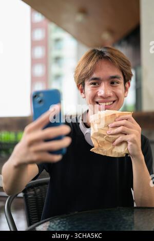A Thai man using mobile phone with forex trading graph Stock Photo - Alamy