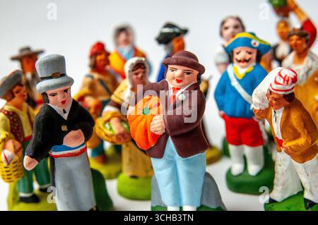 Colorful terracotta Santons figurines depict various characters from ...