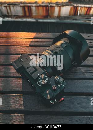 A closeup shot of a camera lens placed on a brown wooden table Stock ...
