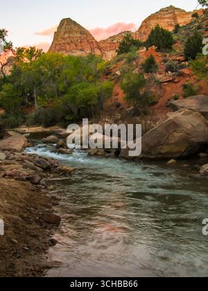 The majestic peak of the Watchman towering over the fast flowing Virgin ...