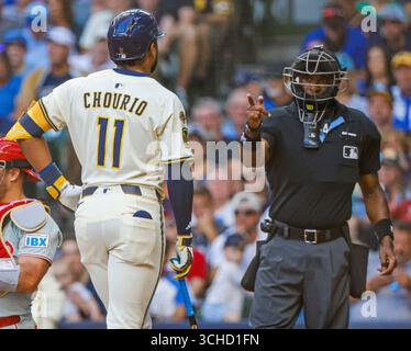 Milwaukee Brewers' Jackson Chourio talks with Garrett Mitchell during a ...