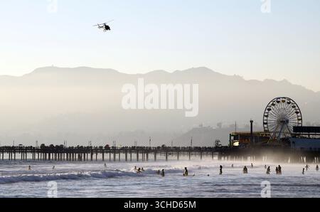 LAPD helicopter flying over the pier in Santa Monica, beach, Los ...