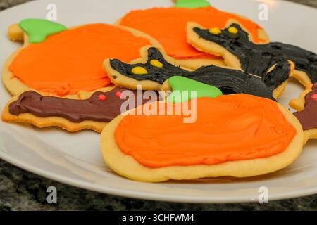 Plate of creative cookies for Halloween celebration on dark wooden ...