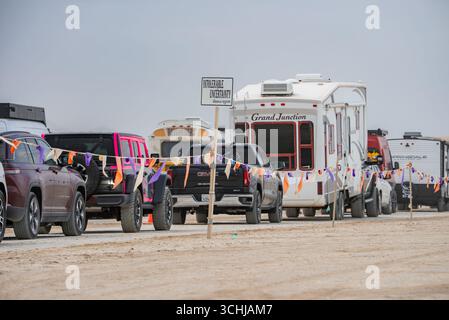 Dusty Road with Vehicles and Flags at Burning Man in Nevada Desert ...