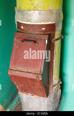 Inner city neglect of a rusted old door and entrance under the bridge ...