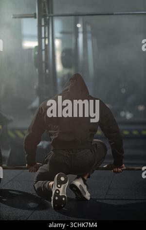 Male athlete lifts the barbell Stock Photo - Alamy