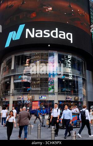 People walk past the Nasdaq MarketSite Times Square event space in ...