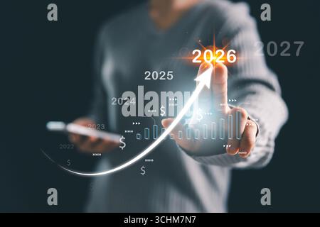 Hand pointing to a glowing upward arrow and stock market chart overlay ...