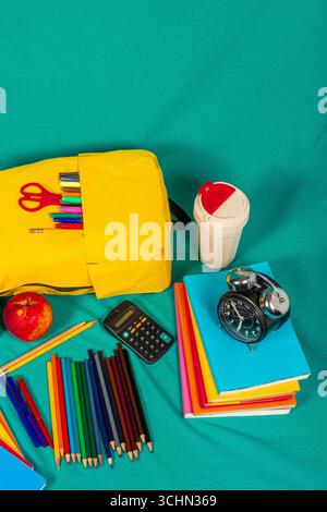 Science and education - alarm clock and high pile group of red books on ...